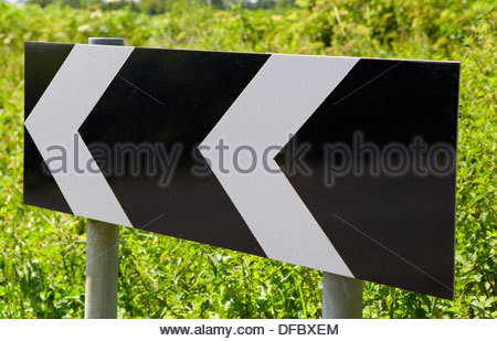 Black and white chevron sign warning sharp lefthand bend on a coast ...