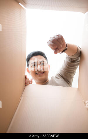 People looking at camera through opening of a closed door, Shanghai ...