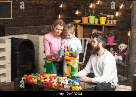 Mom and child build out of colorful plastic blocks Stock Photo - Alamy