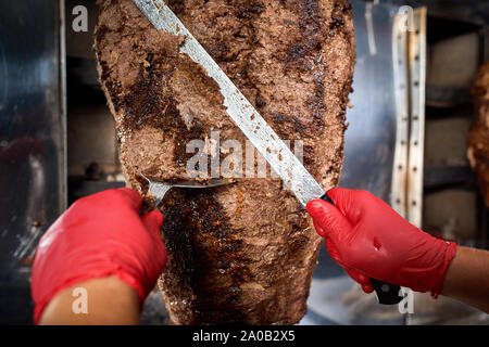 A chicken shawarma skewer roasting on a rotating pole Stock Photo - Alamy