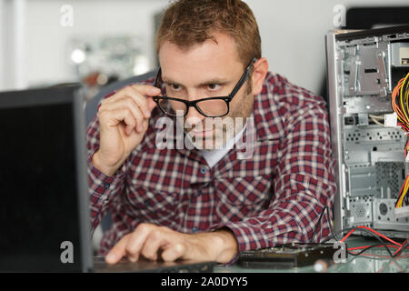 The computer repairman on wheelchair working Stock Photo - Alamy