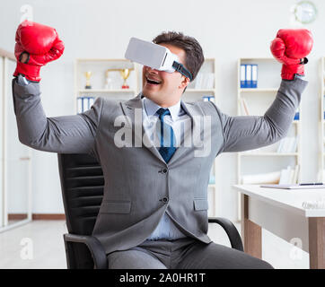 Man boxing in the office with virtual reality goggles Stock Photo - Alamy