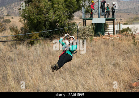 Diverse Adults having fun on a Zip Line ride in the countryside Stock ...