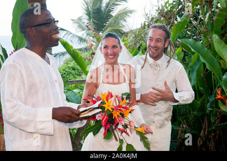 A French couple is getting married outdoors near the ocean in Dominicia ...