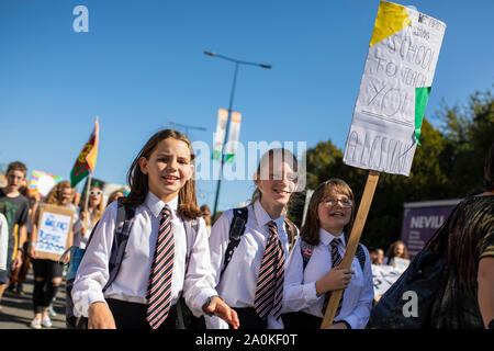 Three schoolgirls in uniform during a protest in Cardiff demanding ...