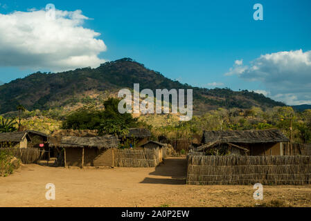 Rural Mozambique village with thatched huts and grain barns on ...