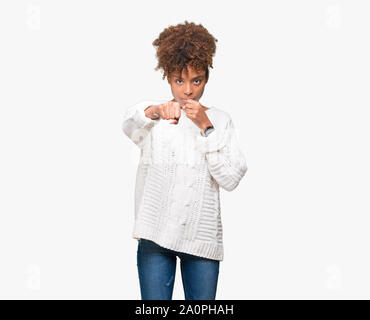 Hispanic woman with white sweater and clenched fist celebrating victory ...