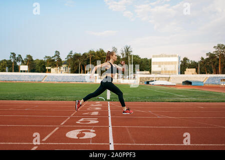 Runner crosses the finish line on a red treadmill with the numbers 2023 ...