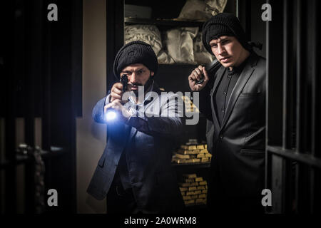 Two ardmed men robbing a bank Stock Photo - Alamy
