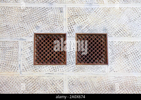 Cast iron ventilation grilles against a plaster wall Stock Photo - Alamy