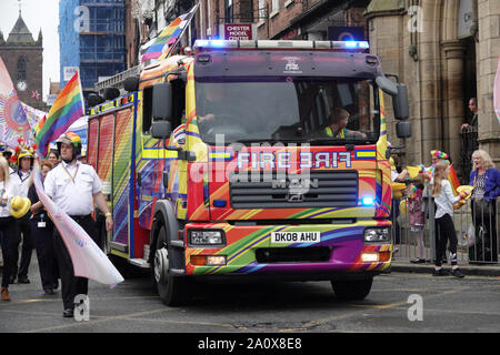 Fire engine painted with Pride rainbow colours, with words Fire doesn't ...