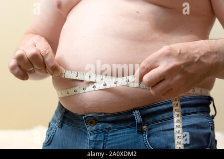 Male fat belly abdomen in tight jeans overweight on isolated white ...