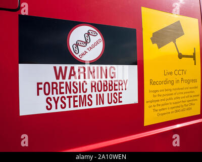 Forensic tagging warning sign on security fence - commit a crime here ...