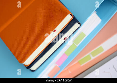 Stack of books with paper foder lie in office against Stock Photo - Alamy