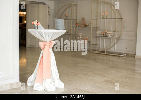 Photo zone for wedding ceremony with decorated frame and chair with ...
