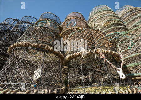 Cuttlefish pots stacked on the quayside at Brixham Harbour. Devon ...