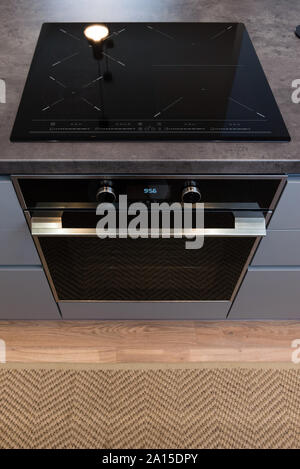 Modern white kitchen with induction cooktop. Induction stove in white ...