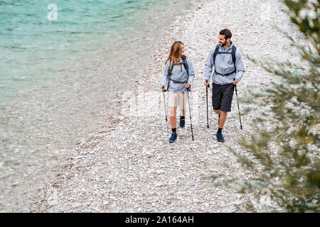 Germany, Bavaria, Female hiker walking toward wayside shrine in ...