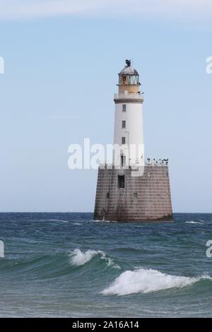 White lighthouse on platform in sea Stock Photo - Alamy