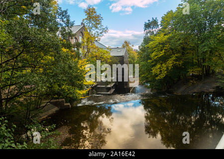 Weir with trees reflected in the River Derwent in Belper Derbyshire ...