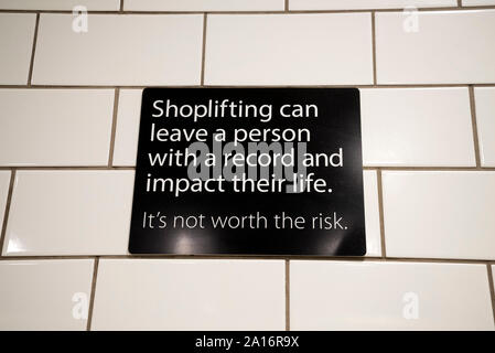 Shoplifting deterrant warning sign on bathroom wall of a department ...