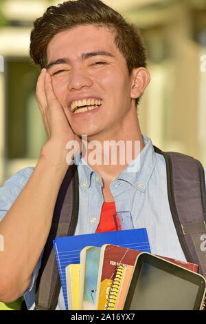 Happy Handsome Filipino Student With Books Sitting Stock Photo - Alamy