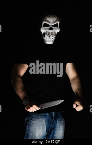 The criminal with a knife in a black mask over white Stock Photo - Alamy