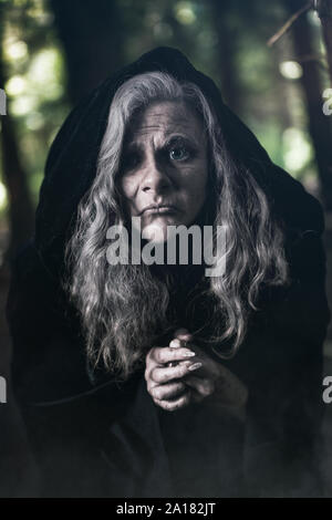 Scary witch in night forest Stock Photo - Alamy