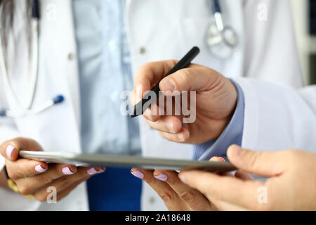 Male GP making electronic notes in tablet pc Stock Photo - Alamy