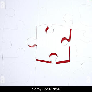 White jigsaw puzzle pattern background. placing last piece of jigsaw ...
