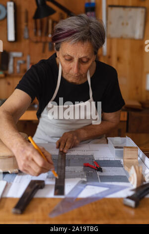 Close-up of violin maker measuring at workshop Stock Photo - Alamy