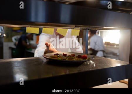 Restaurant staff preparing orders in the kitchen Stock Photo - Alamy