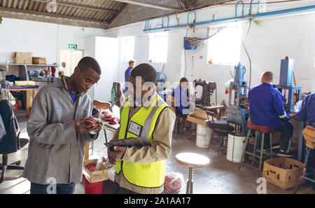 Manager in a factory checking a product from production line. Factory ...