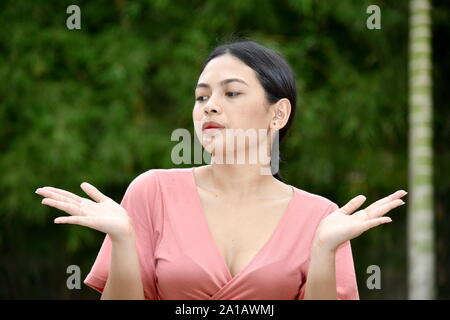 An Undecided Youthful Filipina Woman Stock Photo - Alamy
