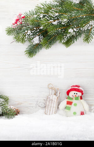 Christmas snowman, sledge toys and fir tree branch. Xmas backdrop with ...