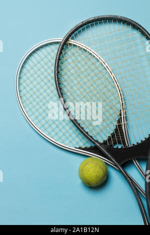 Vintage tennis rackets on a light blue background Stock Photo - Alamy