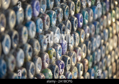 Wall made of recycled plastic bottles filled with trash Stock Photo - Alamy