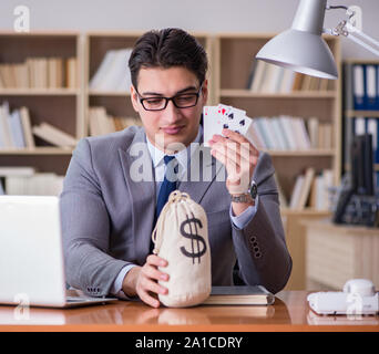 Businessman gambling playing cards at work Stock Photo - Alamy