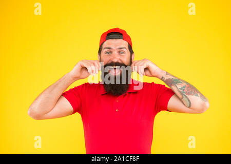 Bearded man twisting moustache. Unshaven man with long beard and ...