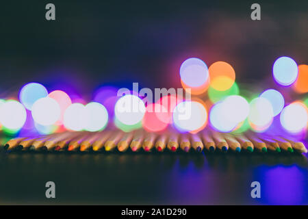 creativity and fun concept, assortment of coloured pencils on dark ...