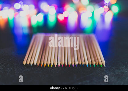 creativity and fun concept, assortment of coloured pencils on dark ...