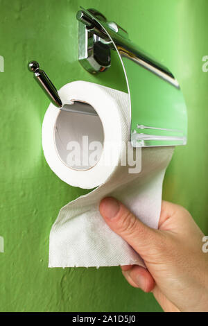 Hand holding rolled public toilet hygiene paper Stock Photo - Alamy