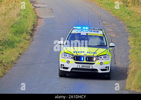 A Police Scotland BMW Police car with blue lights flashing speeding ...