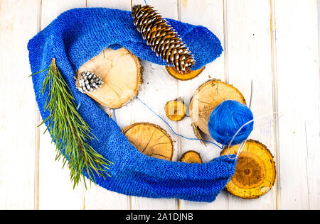 Wood pebble, bumps, cloth and a knitting thread tie on the background ...