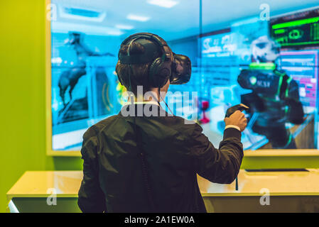Man playing VR games. A new reality. Neon lighting Stock Photo - Alamy