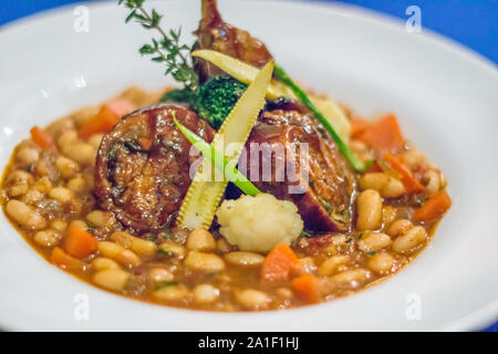 Portuguese Rabbit with White Bean and carrot Stew served in a white ...