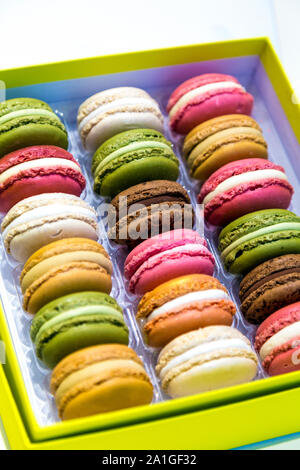 Macaron dessert, a box with colorful macarons lies on a marble style ...
