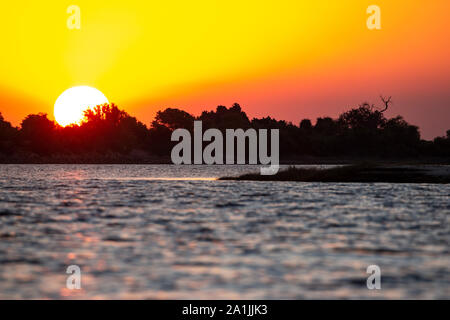 Sun rays over the Chobe River in Chobe National Park in northern ...