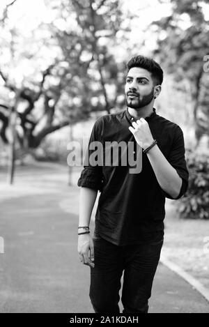 Pensive black man walking outdoors. Introspective pensive African guy ...