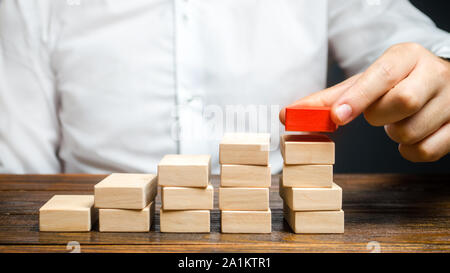 The businessman climbing blocks in career ladder business concept Stock ...